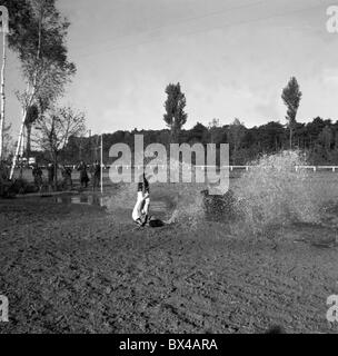 Czechoslovakia," Velka Pardubicka" steeplechase. Jockey nogotiates ...