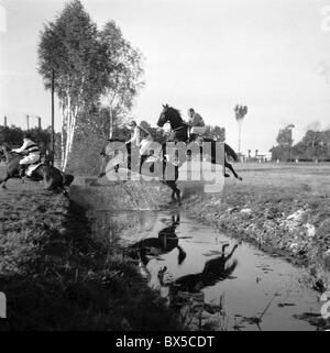 Czechoslovakia," Velka Pardubicka" steeplechase. Jockey nogotiates ...