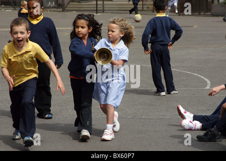 Primary school children ringing the bell in the playground Stock Photo ...