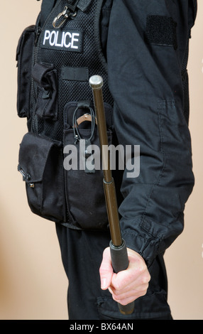 Police officer holding a telescopic baton Stock Photo - Alamy