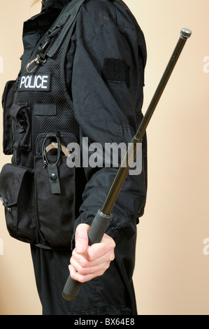 Police officer holding a telescopic baton Stock Photo - Alamy