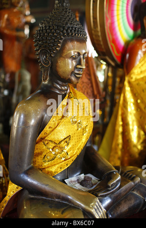 Buddha statue with offerings at Wat Phnom temple Stock Photo - Alamy