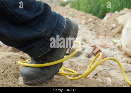 Site hazard tripping over an electric cable Stock Photo - Alamy