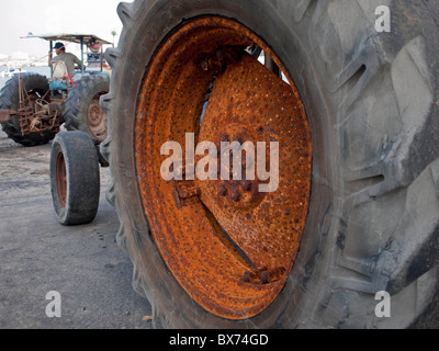 Old tractor tire with rusty wheel with corrosion Stock Photo - Alamy