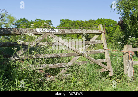 Field entrance with a wooden farm gate with a substantial soft focus ...