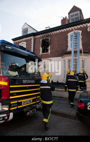 Firemen pitching 135 ladder Fire & Rescue Service UK Stock Photo - Alamy