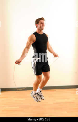 Muscular black man skipping rope. Portrait of muscular young man ...