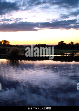 Sunset reflections over the water Stock Photo - Alamy