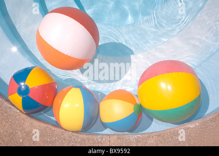 Inflatable beach ball floating in an outdoor swimming pool Stock Photo ...