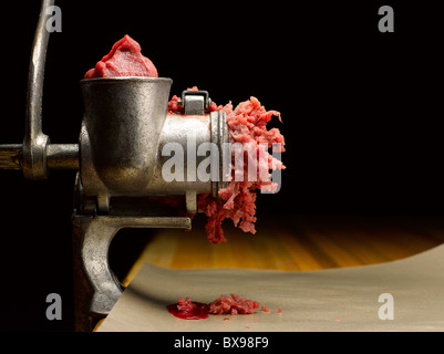 Fresh raw ground beef on wooden cutting board with basil leaves ...