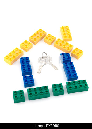 Colorful building blocks and home keys lying on construction drawing of ...