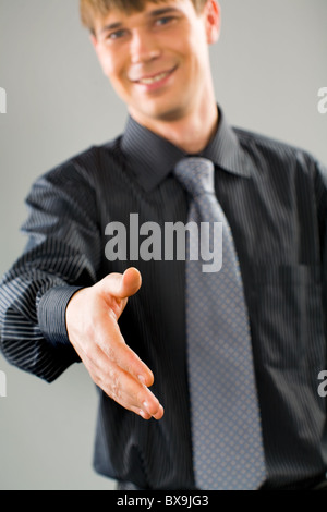 Business man saying welcome and giving hand Stock Photo - Alamy