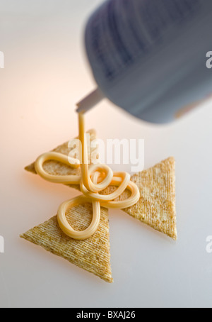 Canned spray cheese and a saltine cracker Stock Photo - Alamy