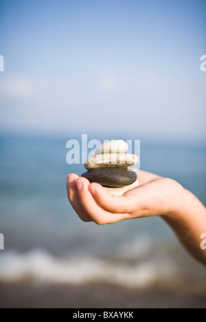 Child holding stones in hands Stock Photo - Alamy