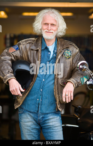 The man in a helmet holding a light bulb Stock Photo - Alamy