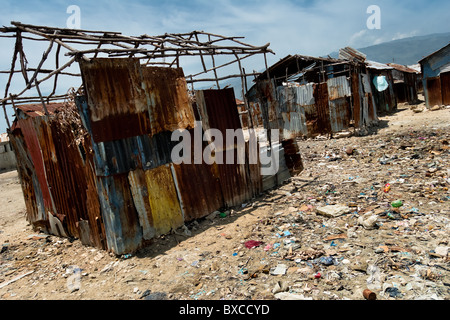 Shanty town of "City Soleil", Haiti. This woman rests(poses) in front ...