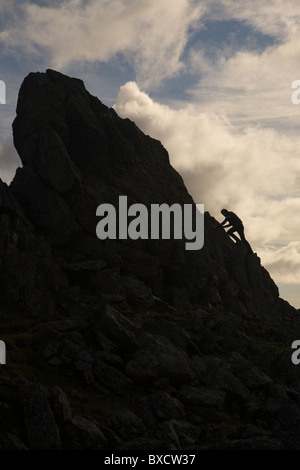 Portrait of young man climbing crag, smiling Stock Photo - Alamy