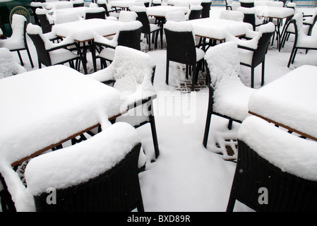 Snow covered tables and chairs in a restaurant Switzerland Stock Photo - Alamy