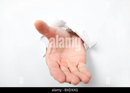Hand punching through white paper and ok sign Stock Photo - Alamy