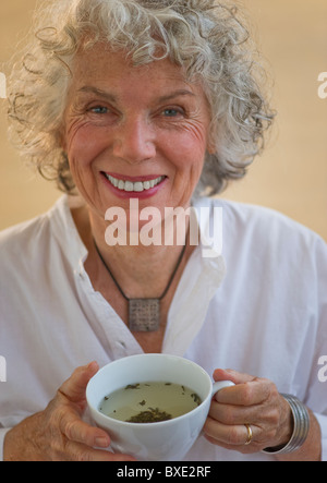 Portrait of smiling peaceful woman relaxing on lotus position sitting ...