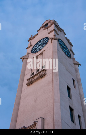 A clock tower building with timepieces on front and side Stock Photo ...