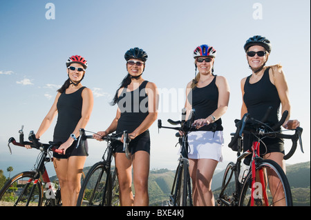 Cyclists standing beside their bikes on the side of the road Stock ...