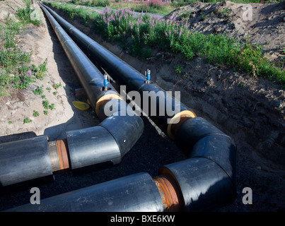Insulated pipes for underground district heating. Connecting a new building to heat system Stock ...