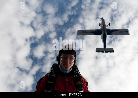 Skydiver girl is practise the head down position and flying free over ...