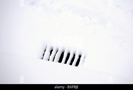 Drain covered in snow Stock Photo - Alamy