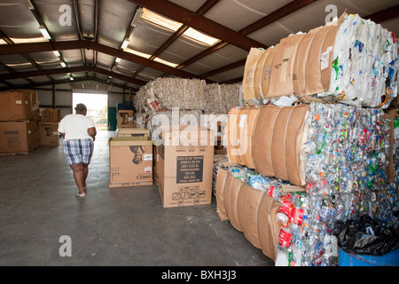 Bales of compacted plastic waste stacked high at recycling center in ...