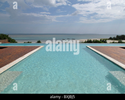 View over an infinity pool on a slope above a tropical beach in the ...