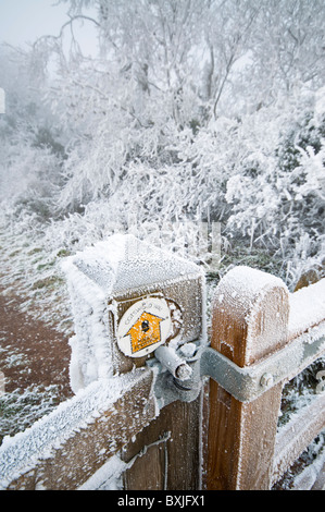 Frost covered kissing gate with Cotswold Way sign, Haresfield Beacon ...