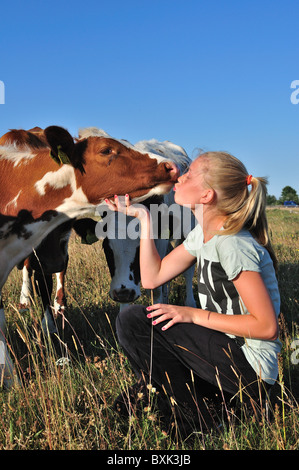 A young girl kissing a young heifer on her mule Stock Photo - Alamy