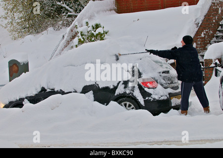 A woman clears snow off her car Stock Photo - Alamy