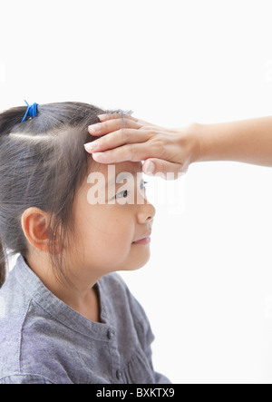 mother's hand on daughter's forehead Stock Photo - Alamy