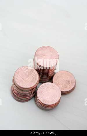 A stack of sterling 1p coins seen from above with an out of focus coin ...