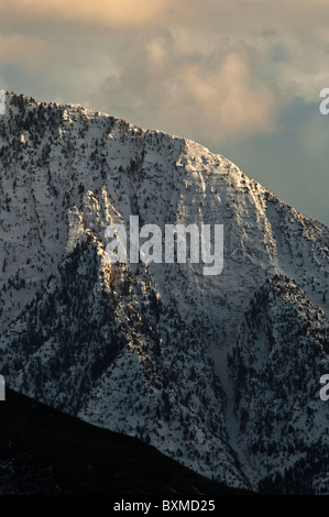 Sheer rock face covered with snow and ice in low light at dusk Stock ...