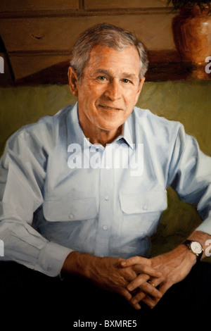 US President George W. Bush lays down on the jogging track to play with ...