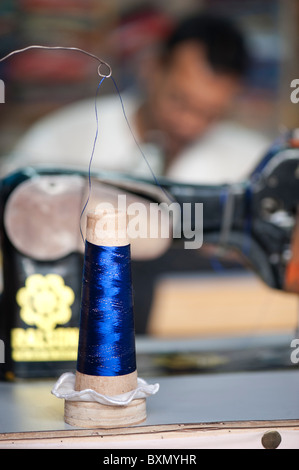 Local Indian man at work sewing on an old fashioned sewing machine on ...