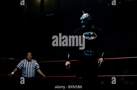 A wrestler disguised as super hero Batman celebrates during a Lucha ...