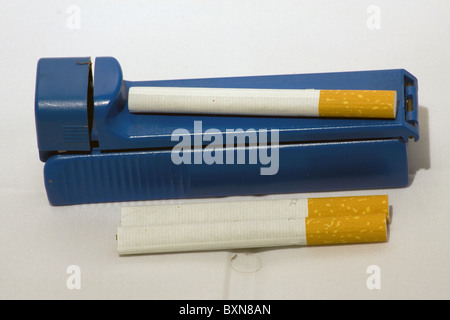 blue cigarette rolling machine filter tip tipped Stock Photo - Alamy