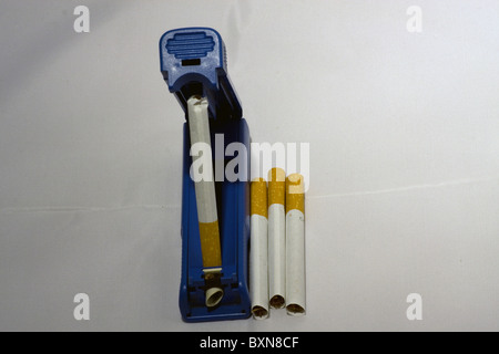 blue cigarette rolling machine filter tip tipped Stock Photo - Alamy