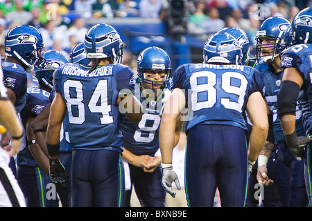 Seattle Seahawks players huddle during warmups before an NFL football ...