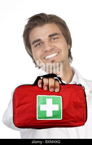 Man with first aid kit in the office Stock Photo - Alamy