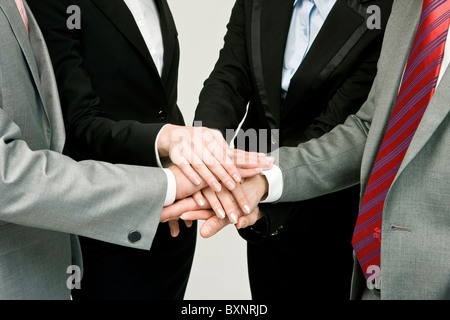 Four business people overlapping hands over globe, elevated view Stock ...