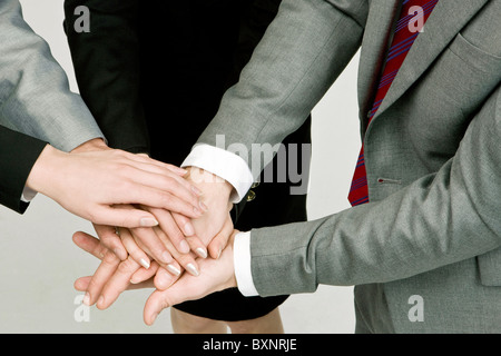Four business people overlapping hands over globe, elevated view Stock ...