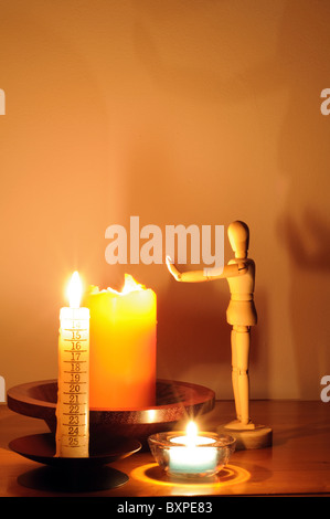 Hands warming at candle flame Stock Photo - Alamy