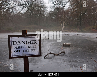 Danger, thin ice sign keep off the ice Stock Photo - Alamy