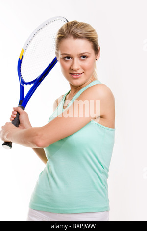 Beautiful sporty lady holding tennis racket and looking away with ...