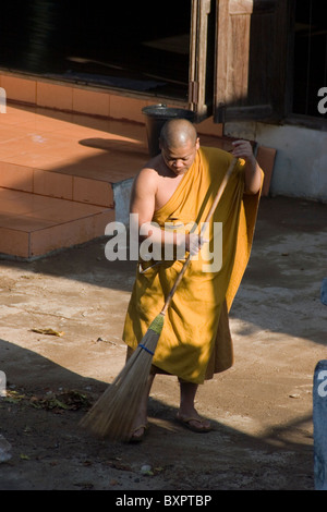 Buddhist monk sweeping temple grounds in the historic town of Galle ...
